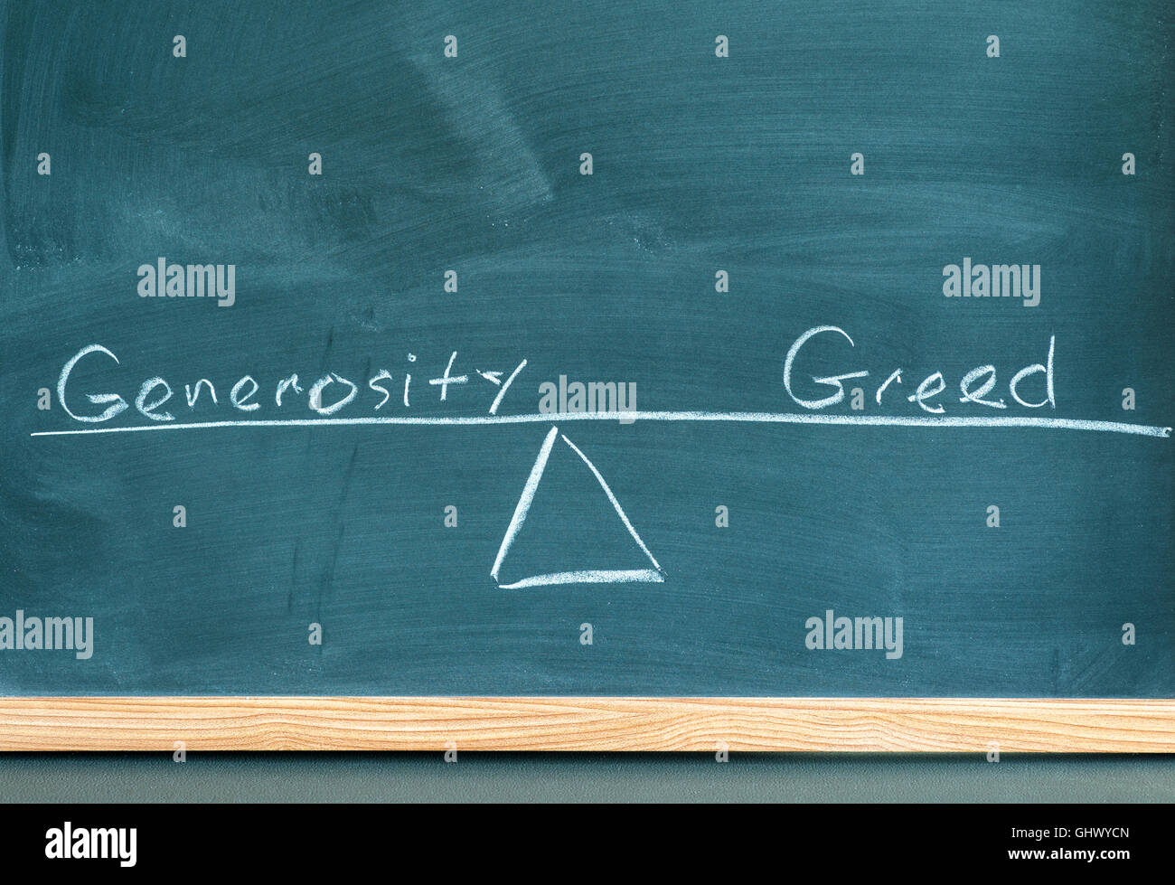 the words generosity and greed on a scale in equilibrium written on a ...