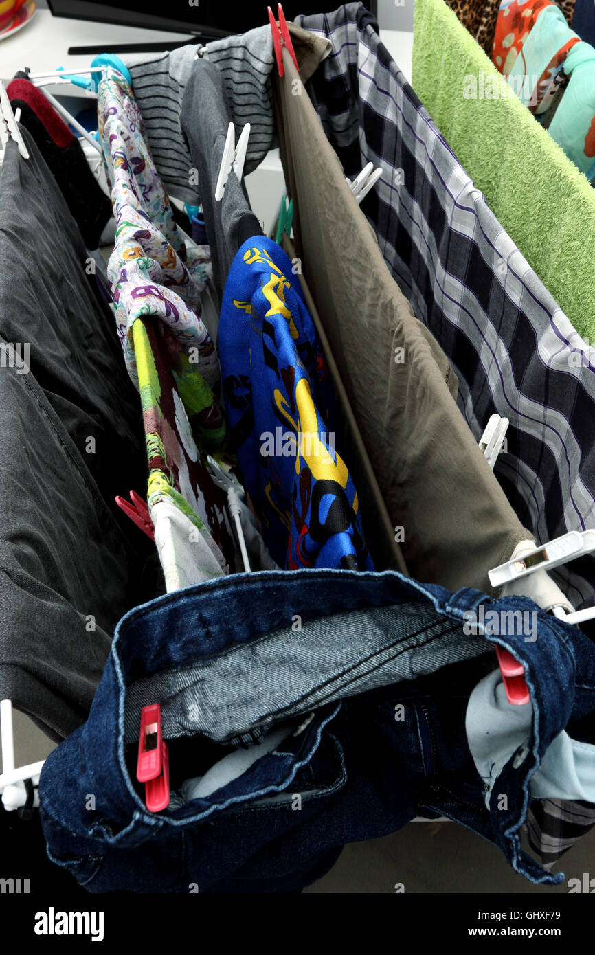 Clothes hanging to dry on a laundry line - indoor Stock Photo - Alamy