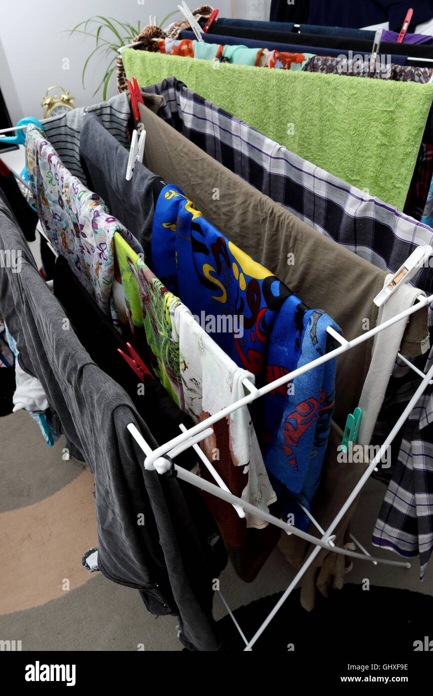 Clothes hanging to dry on a laundry line - indoor Stock Photo - Alamy