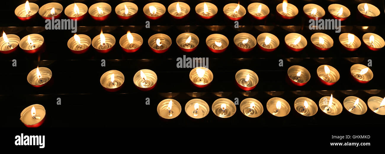 many candles lit inside the place of worship Stock Photo - Alamy