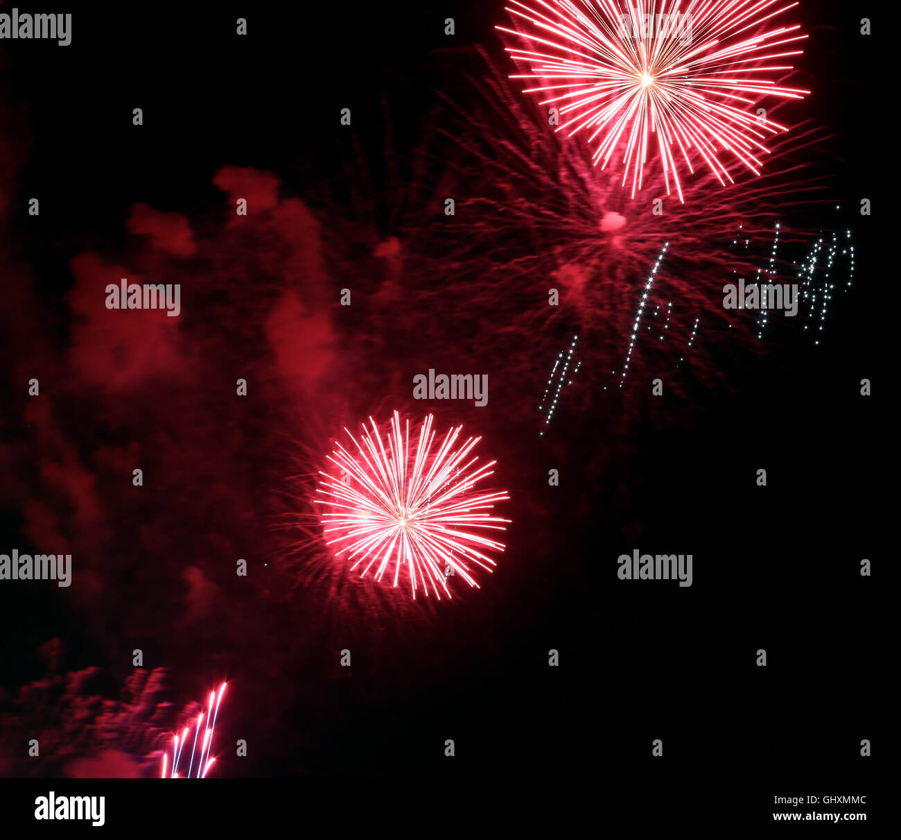 show with red colorful fireworks in the dark sky Stock Photo - Alamy