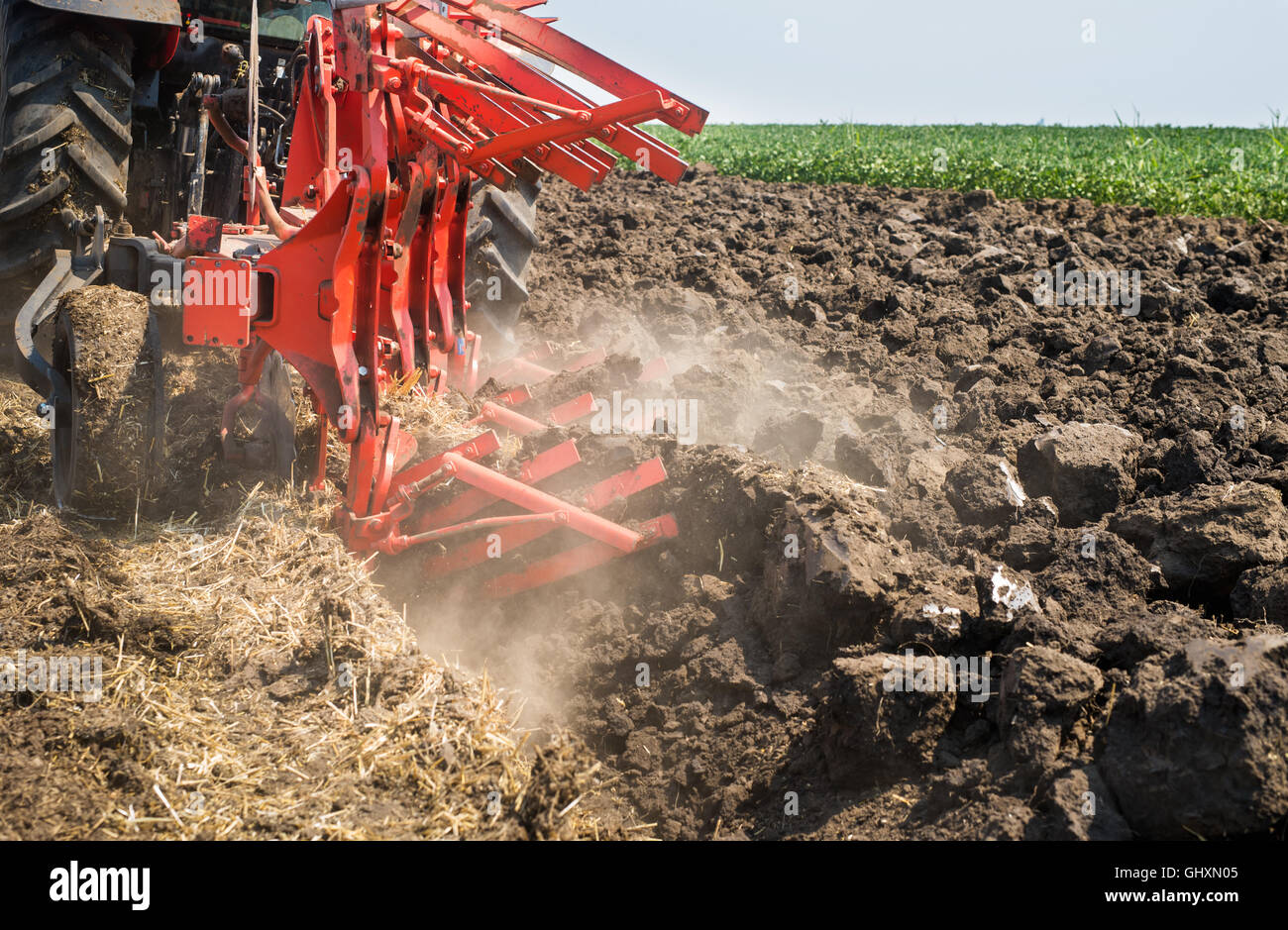 Tractor plowing the stubble field Stock Photo - Alamy