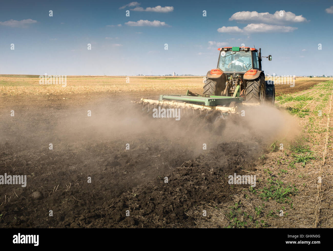 Tractor preparing land for sowing Stock Photo - Alamy