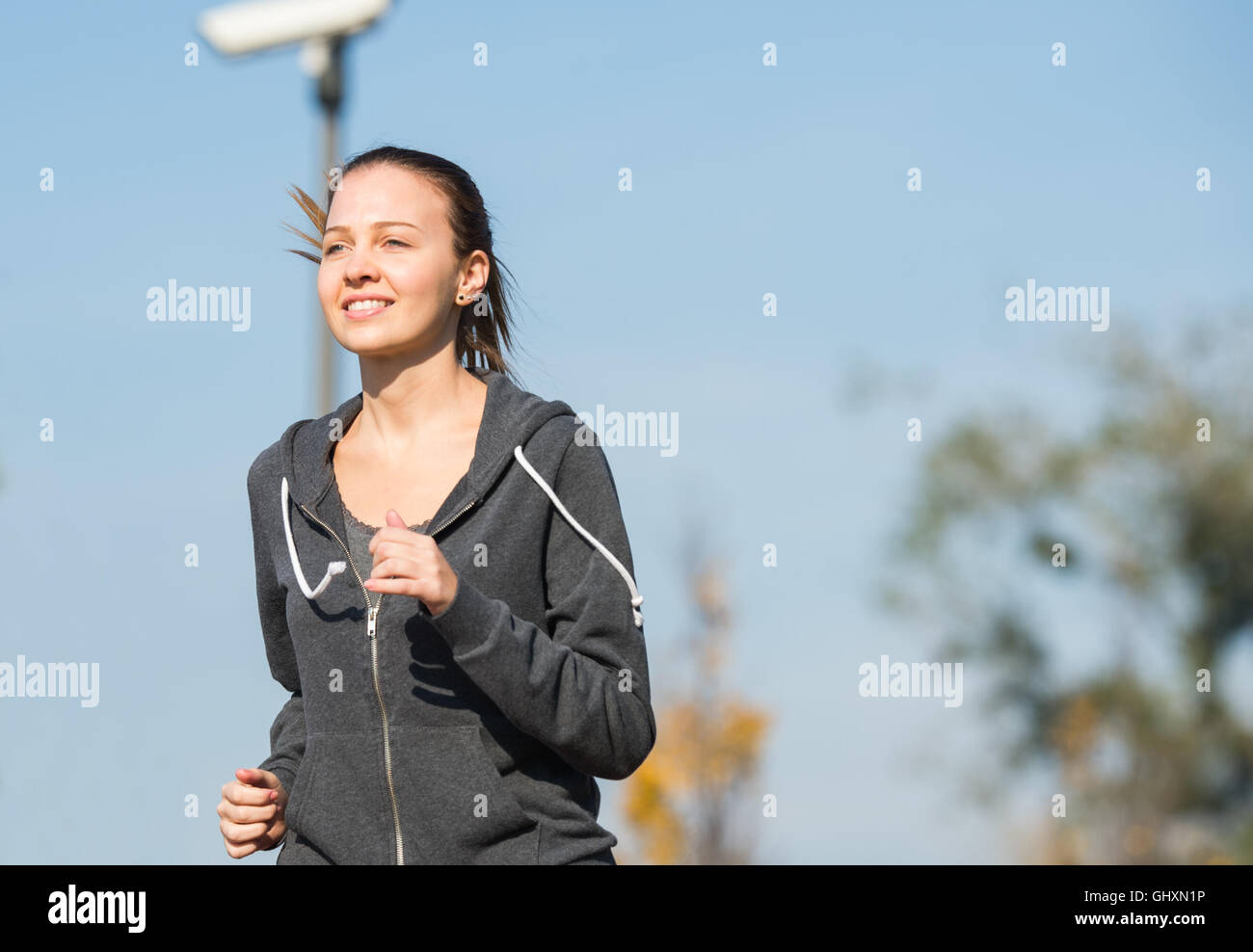 Young girl jogging in the park Stock Photo - Alamy