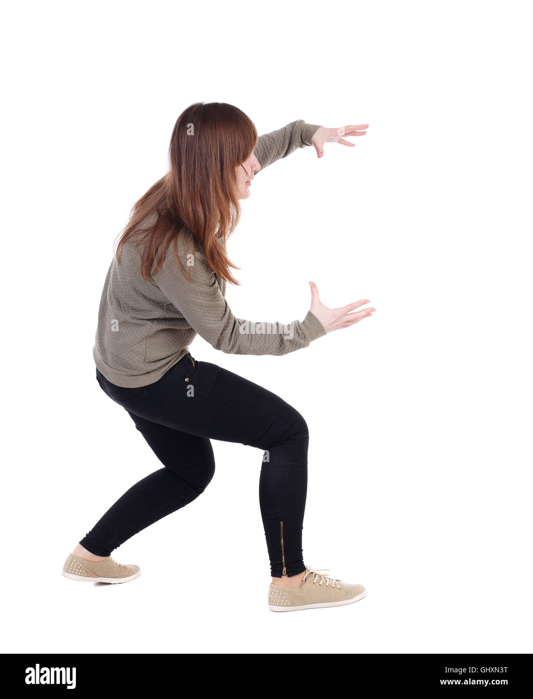 back view of woman protects hands from what is falling Stock Photo - Alamy