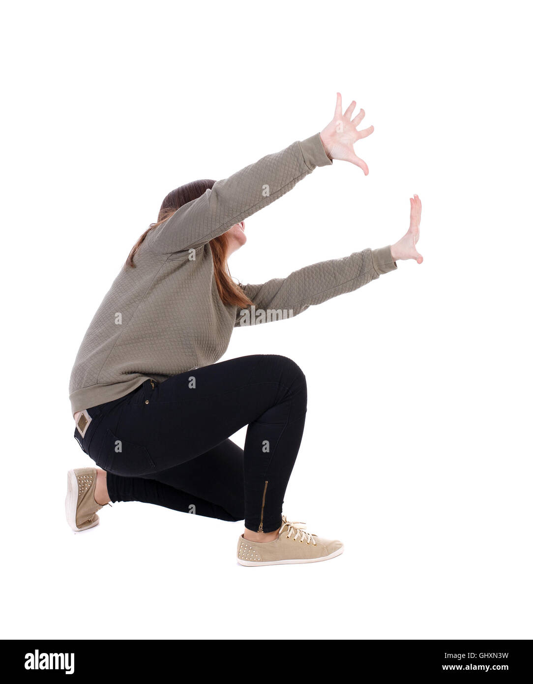 back view of woman protects hands from what is falling Stock Photo - Alamy