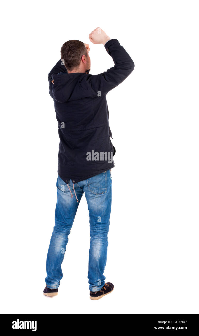 Back view of man. Raised his fist up in victory sign Stock Photo - Alamy