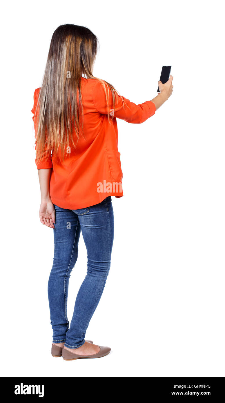 back view of standing young beautiful woman using a mobile pho Stock ...