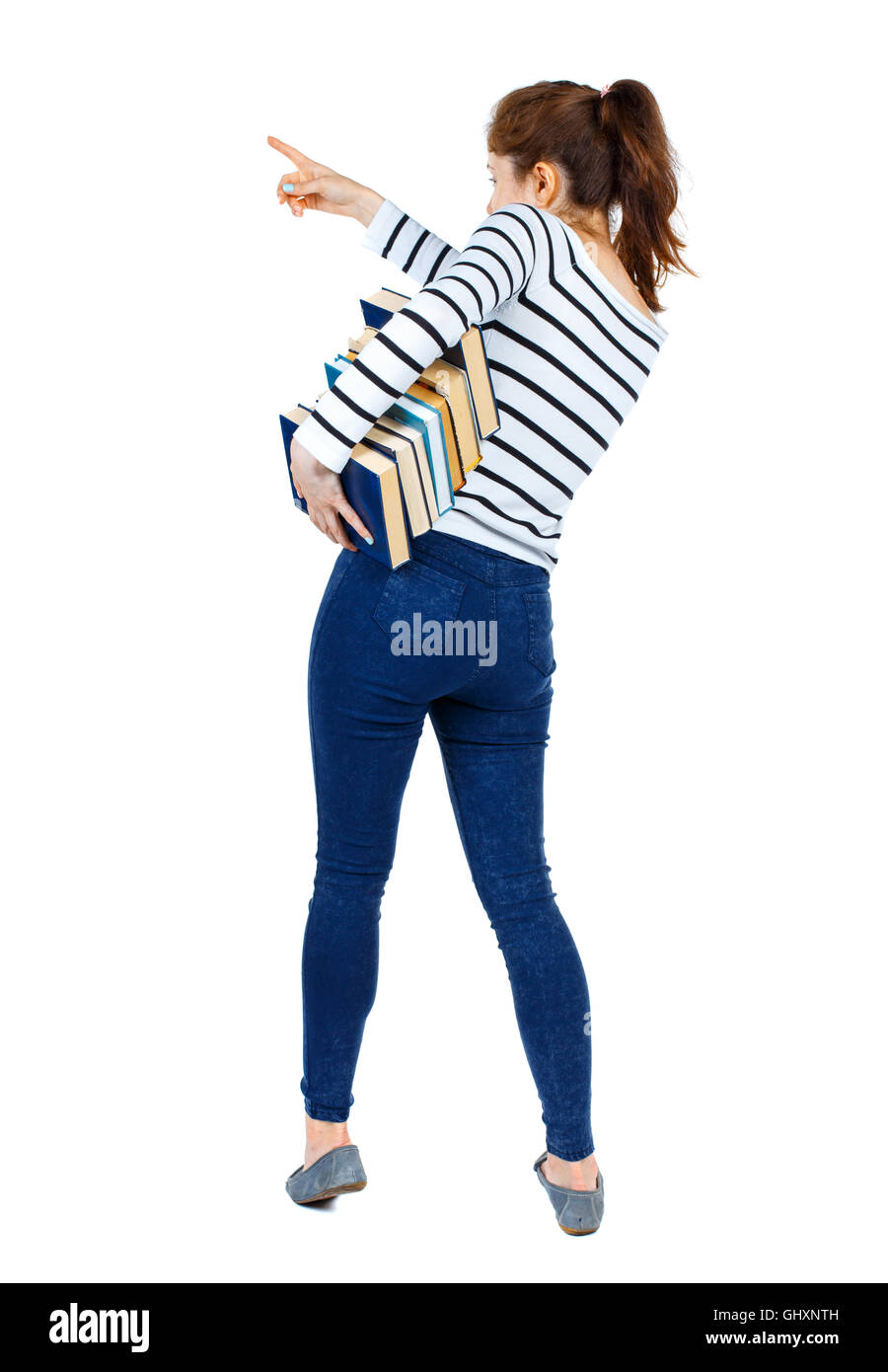 Girl with a stack of books points the finger Stock Photo - Alamy