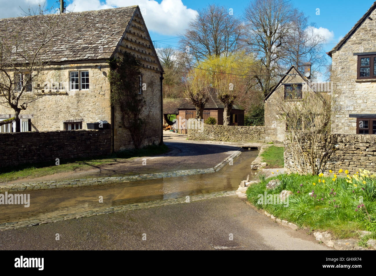 Picturesque Cotswold cottages cluster around the Dunt Stream ford in ...