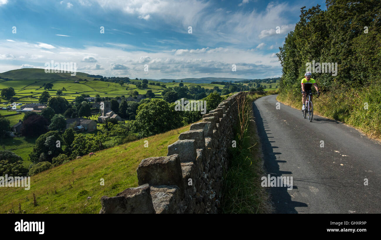 Cyclist cycling the quiet Yorkshire roads above Burnsall village is ...