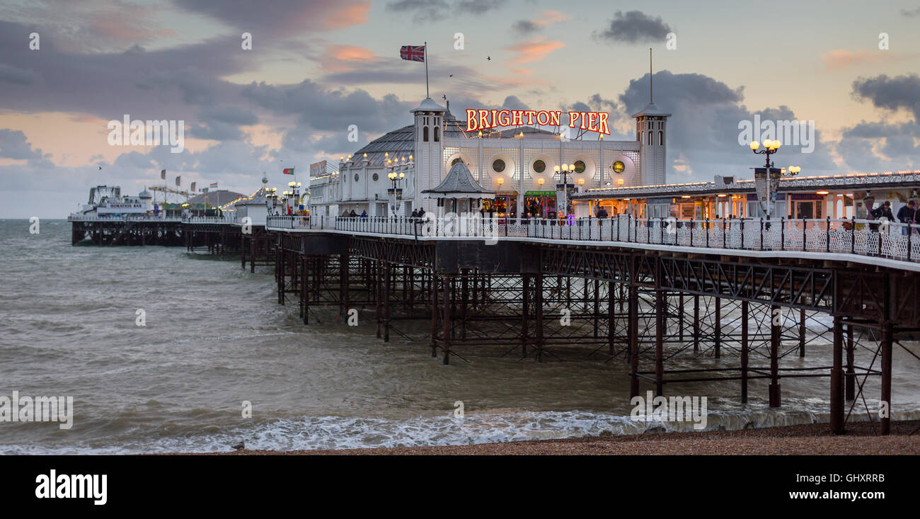 A panoramic photograph of Brighton Pier with a colourful evening sky ...