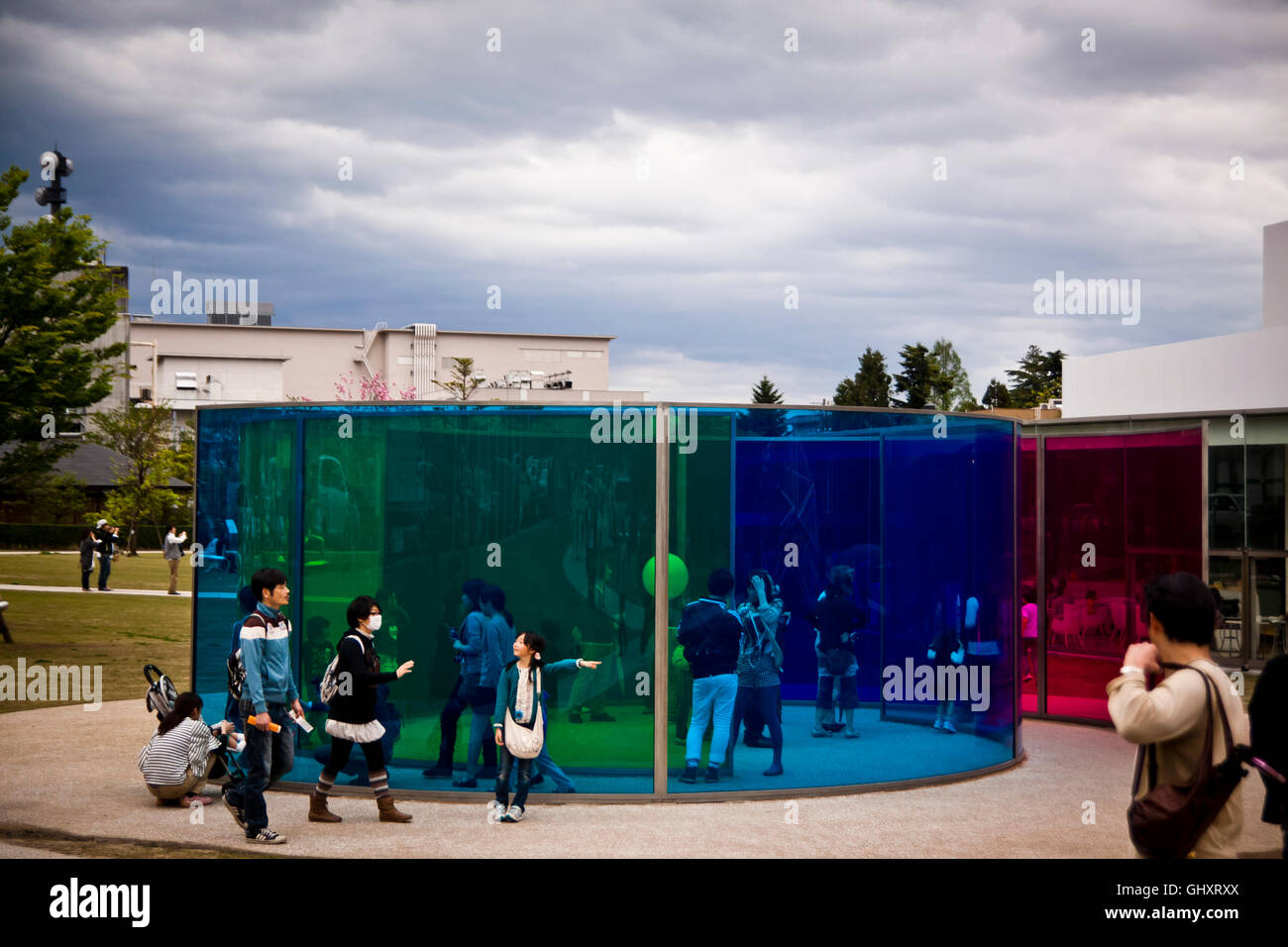 Visitors walk through an installation of coloured glass at the museum ...