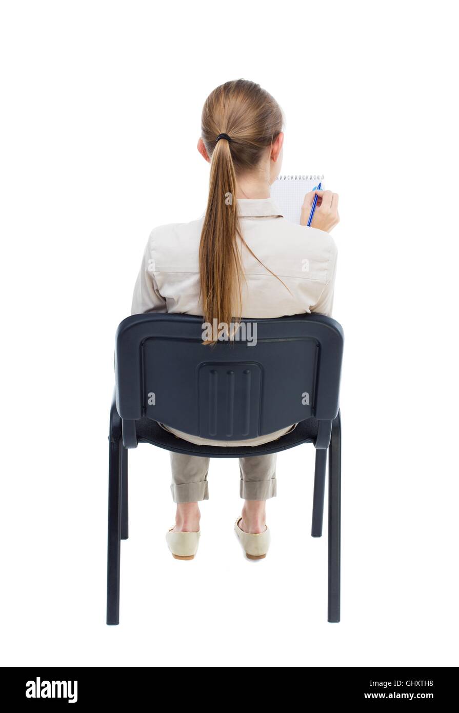 back view of young beautiful woman sitting on chair Stock Photo - Alamy