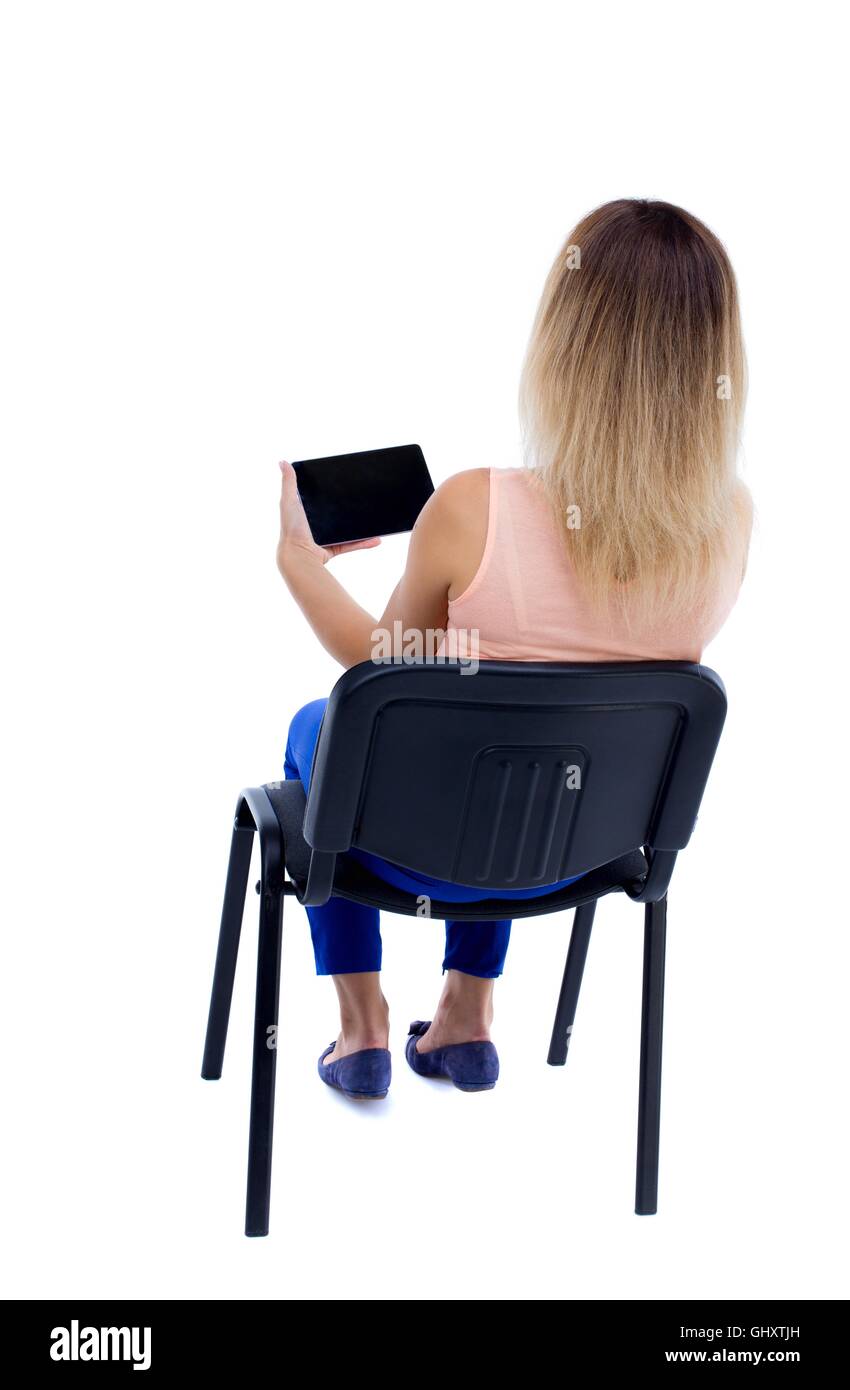 back view of woman sitting on chair Stock Photo - Alamy