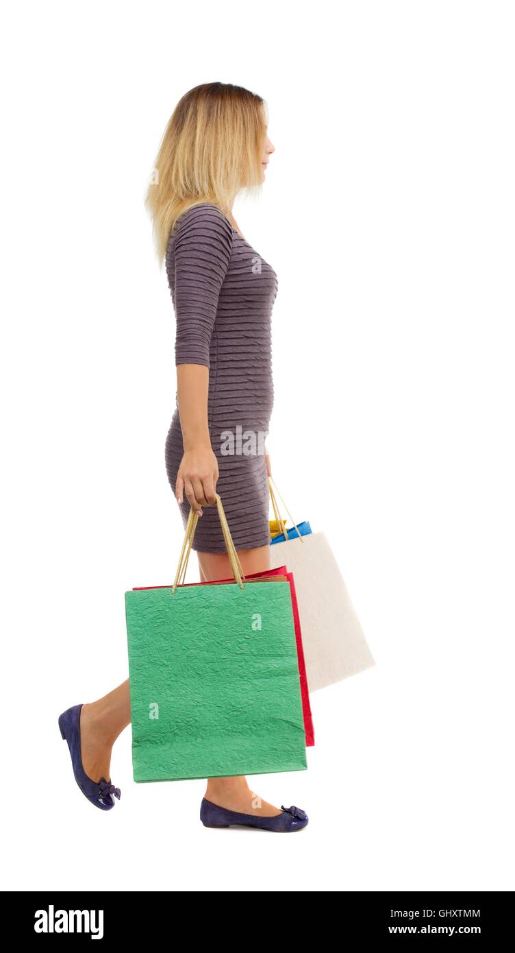back view of going woman with shopping bags Stock Photo - Alamy