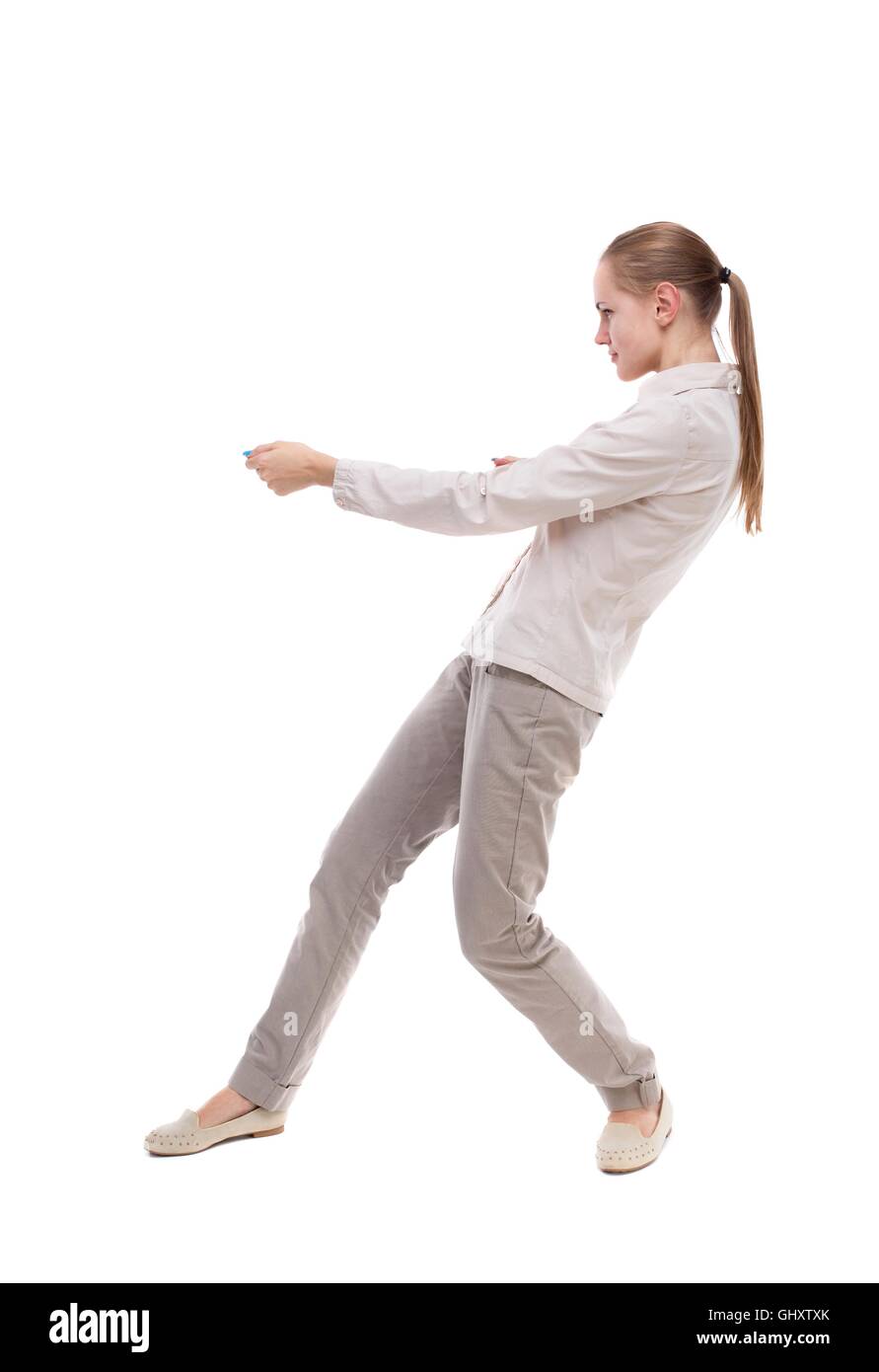 back view of standing girl pulling a rope from the top or cling Stock ...