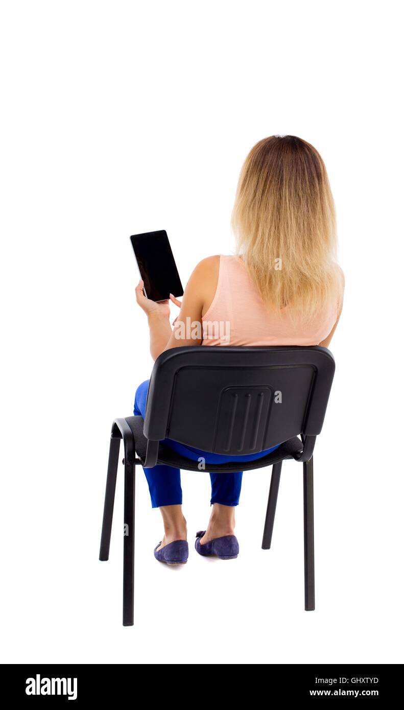 back view of woman sitting on chair Stock Photo - Alamy