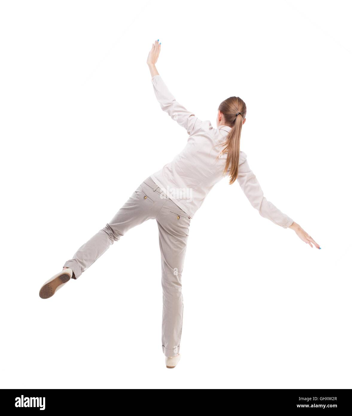 Balancing young woman Stock Photo - Alamy