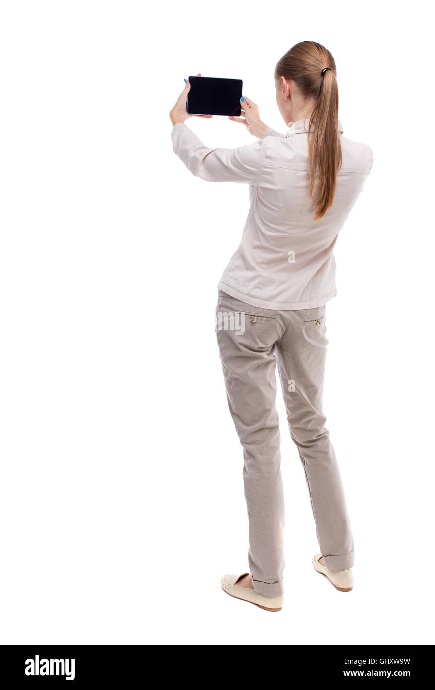 back view of standing young beautiful girl with tablet computer Stock ...