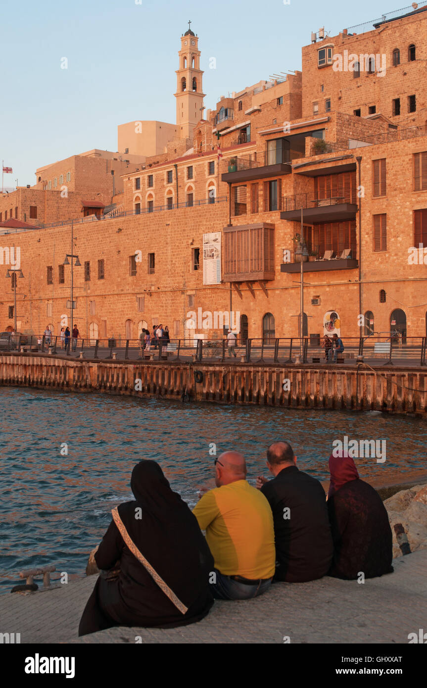 Israel: a muslim family seated at the port of Jaffa with view of the ...