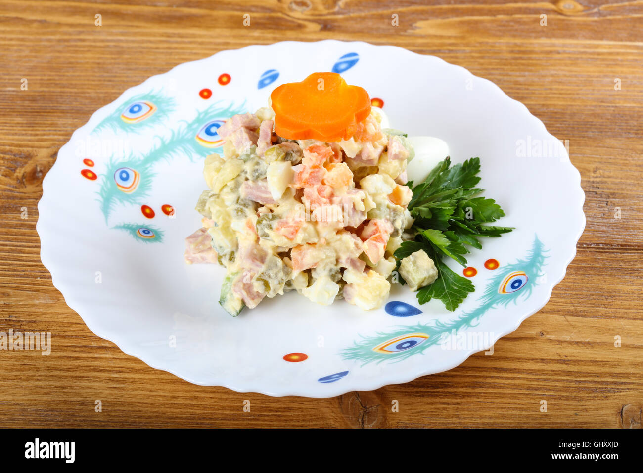 Famous Russian salad with parsley and eggs Stock Photo - Alamy