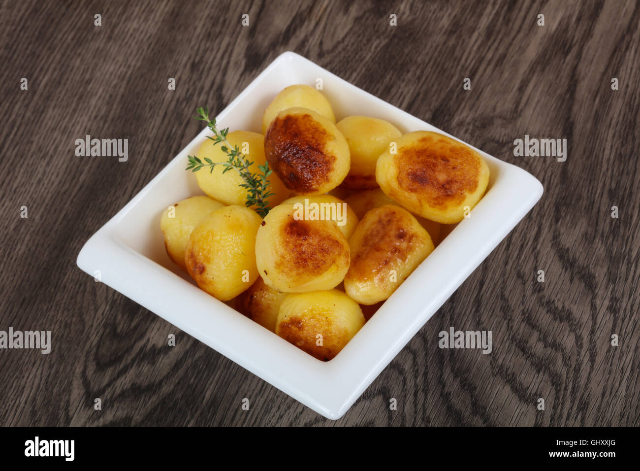 Golden backed potato with thyme branch Stock Photo - Alamy