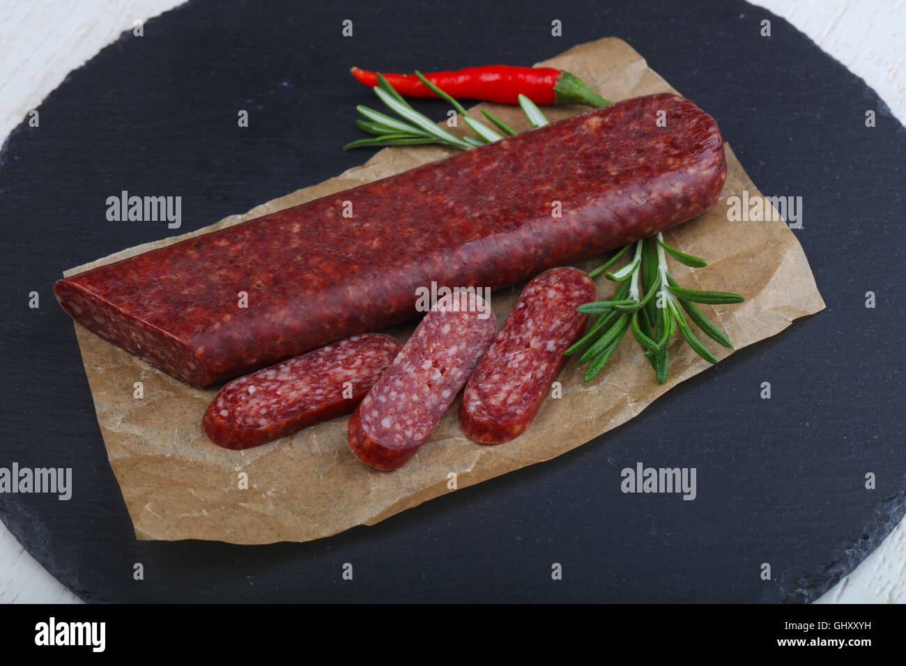 Dry salami with rosemary on the wood Stock Photo - Alamy