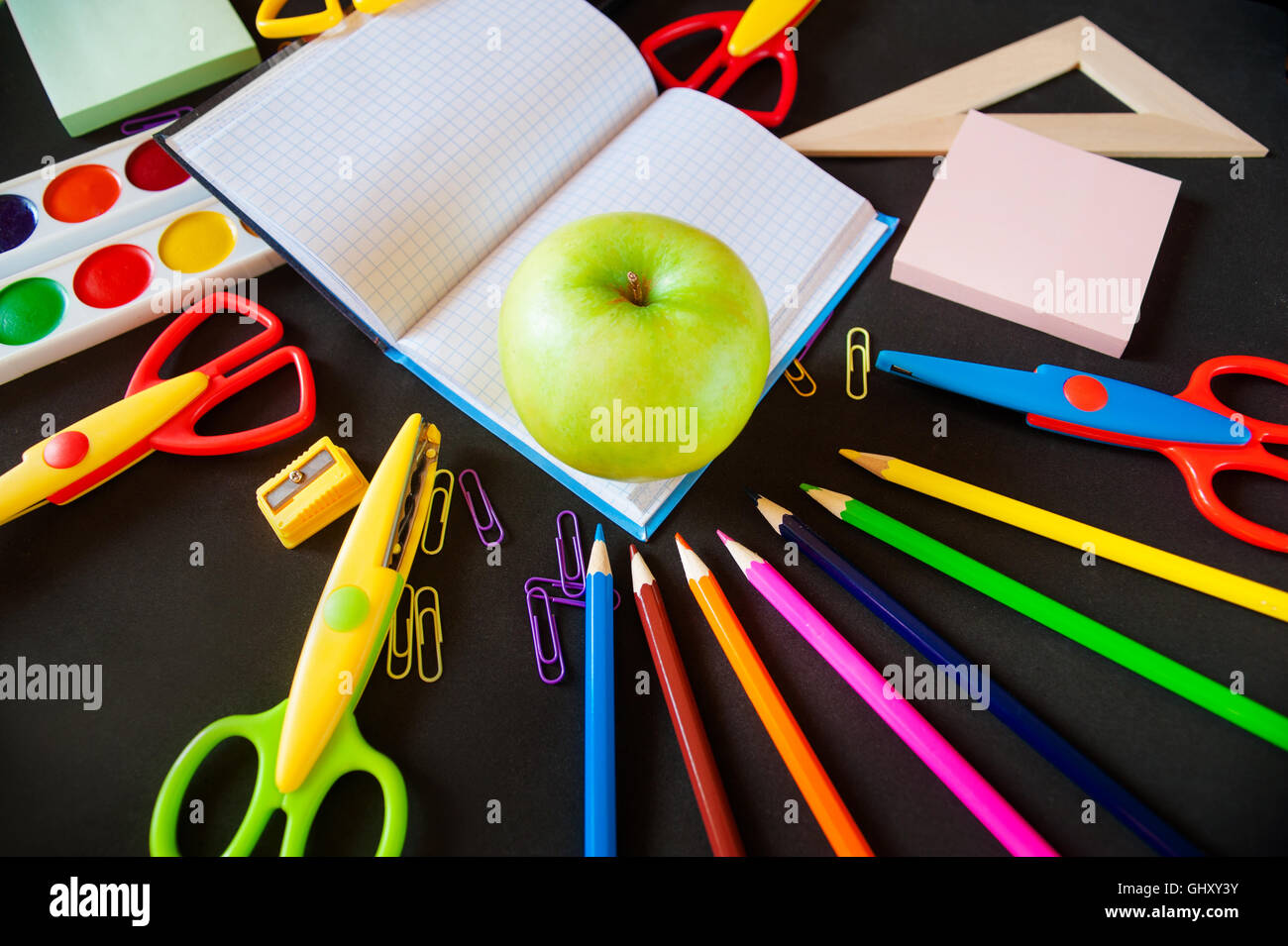 Back to school. Notepad with apple and supplies Stock Photo - Alamy