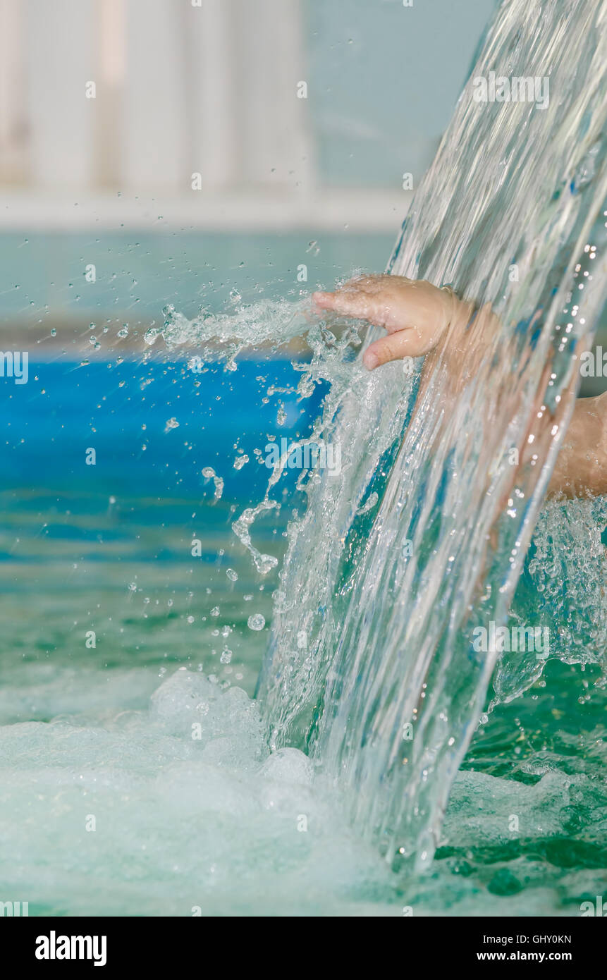 Hand of child creates splashes in the water flow Stock Photo - Alamy