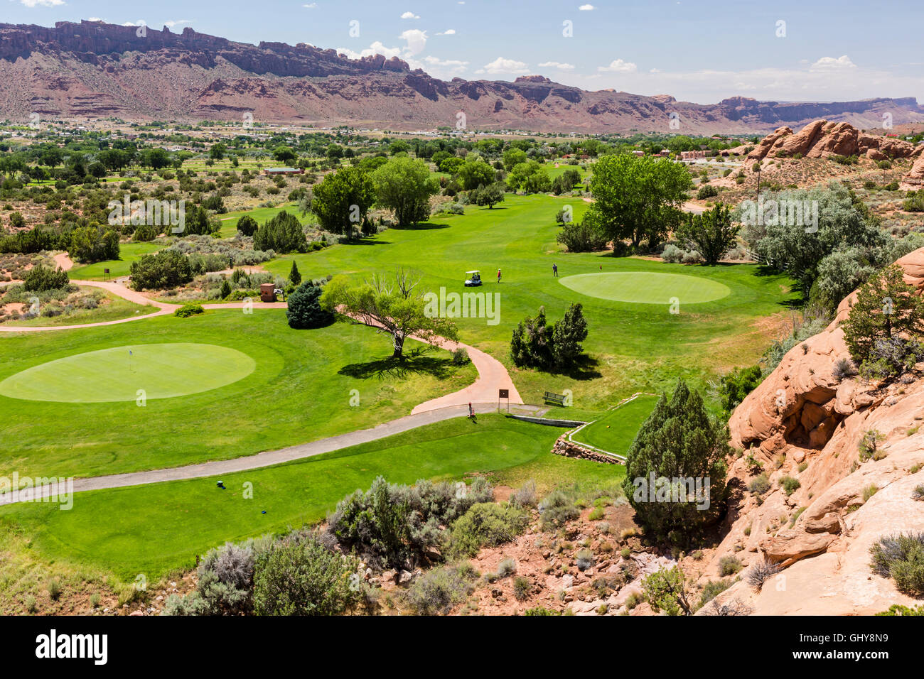 A pair of golfers on the 14th Green of the picturesque Moab Golf Course ...