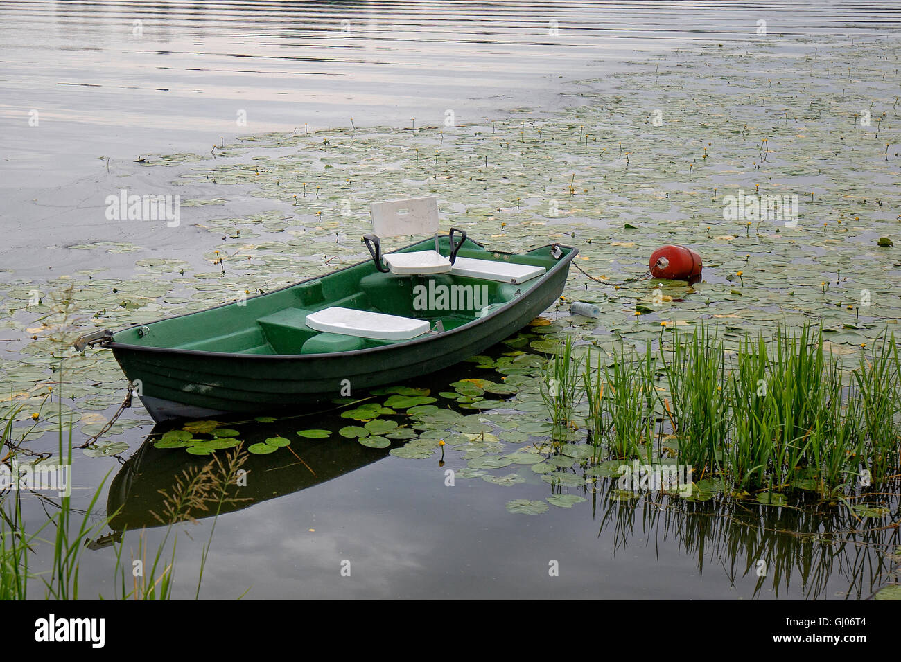 Green boat on the lake Stock Photo - Alamy