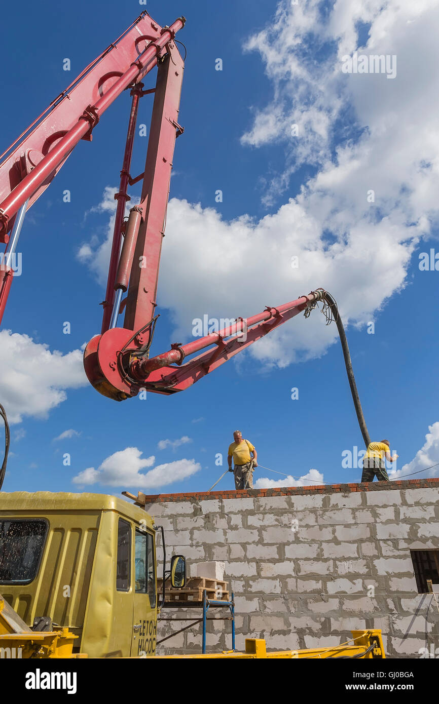 Workers poured concrete using a concrete pump with a vibrator Stock ...