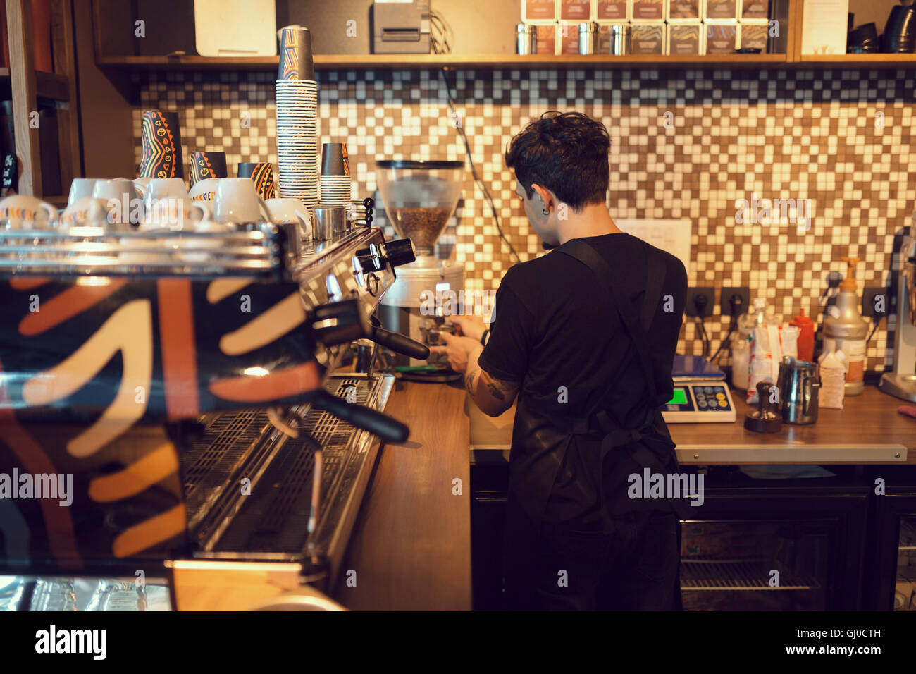Barista at work in a coffee shop Stock Photo - Alamy