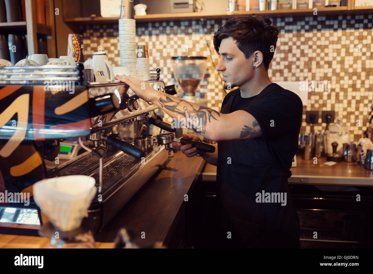 Barista at work in a coffee shop Stock Photo - Alamy