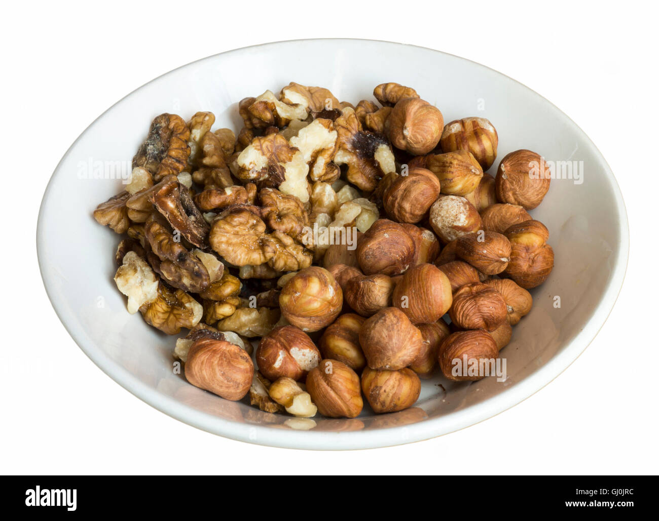 Timber nuts in plate is insulated on white background Stock Photo - Alamy