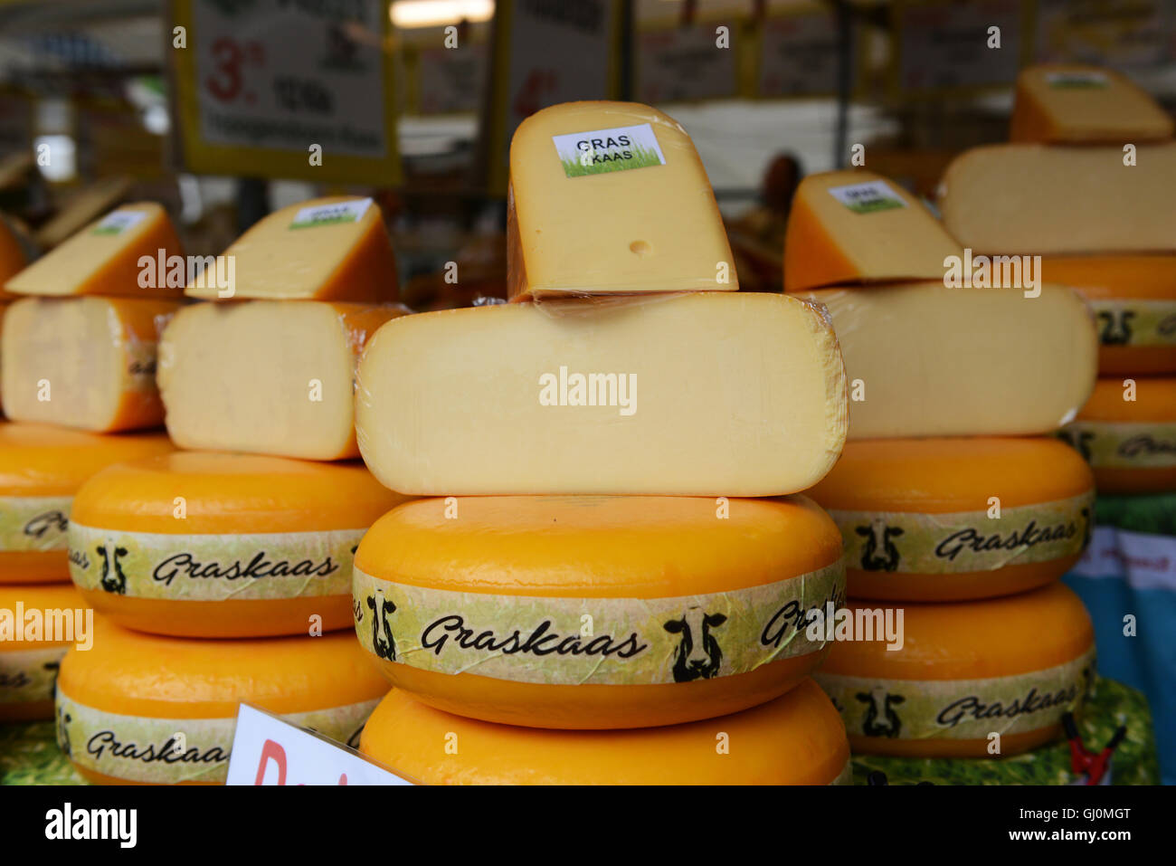 Wheels of Graskaas yellow cheese sold at the colorful outdoor market in ...