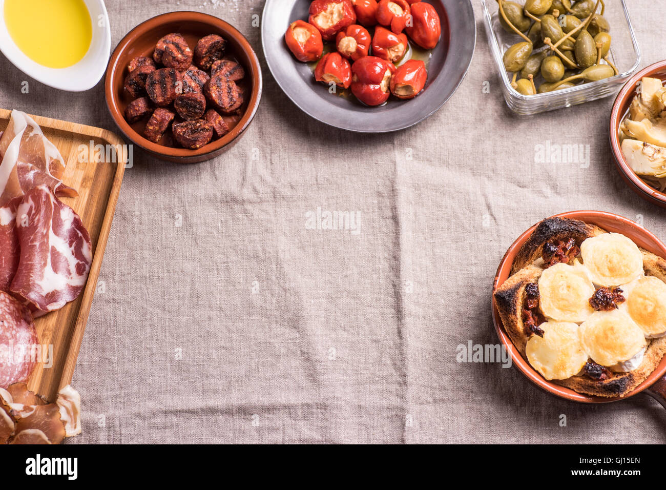 Tapas food, served in small bowls cold meat, goat cheese. A meal for ...