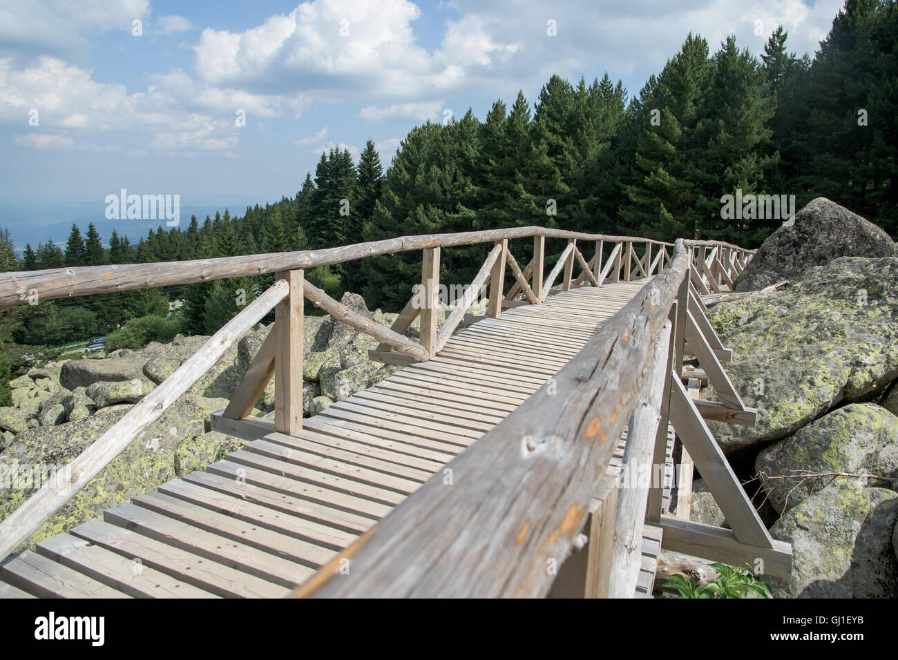 Wooden bridge across the mountain Stock Photo - Alamy