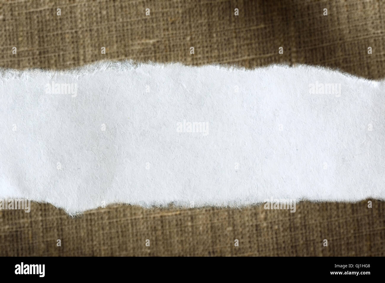 Ragged piece of paper on sack background Stock Photo - Alamy