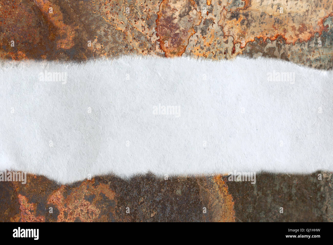 Ragged piece of paper on rusty background Stock Photo - Alamy