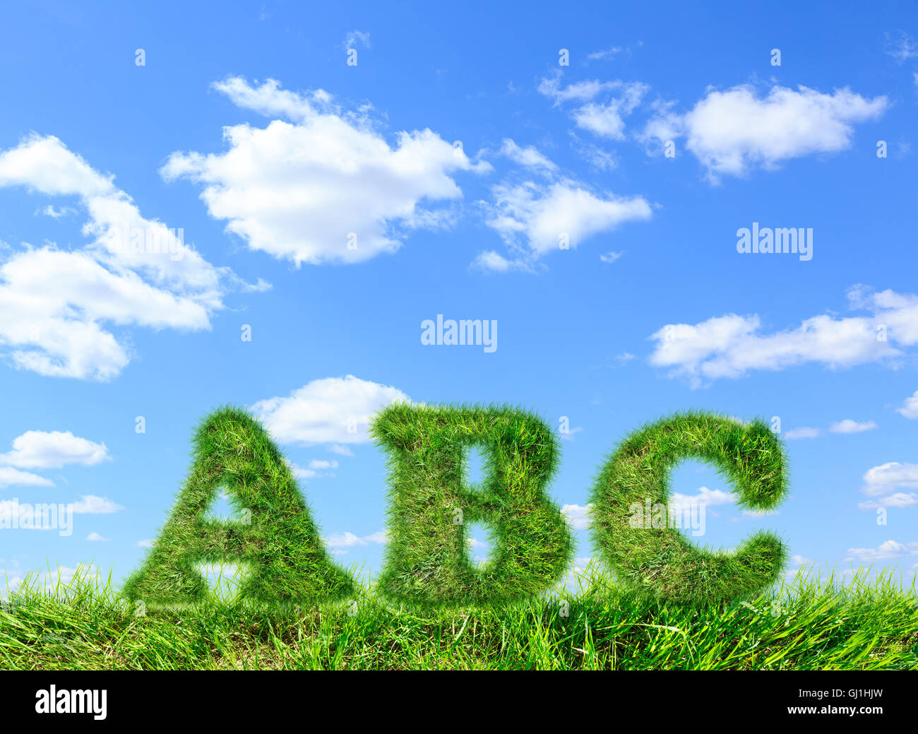 ABC made of green grass on blue sky background Stock Photo - Alamy