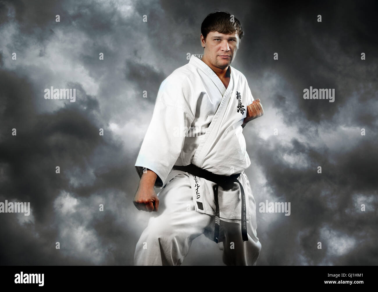 Karate master in kimono on stormy sky background Stock Photo - Alamy