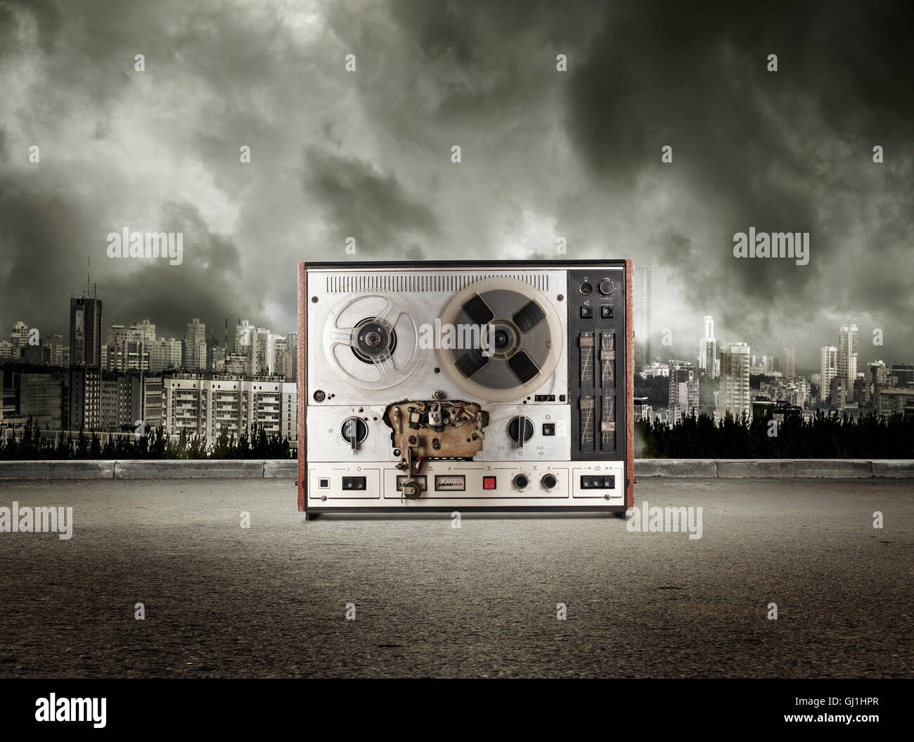 Old reel tape recorder on view of city in stormy sky background Stock ...