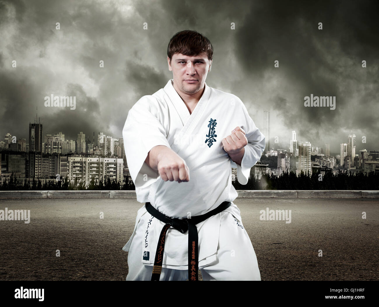 Karate master in kimono on stormy sky background Stock Photo - Alamy