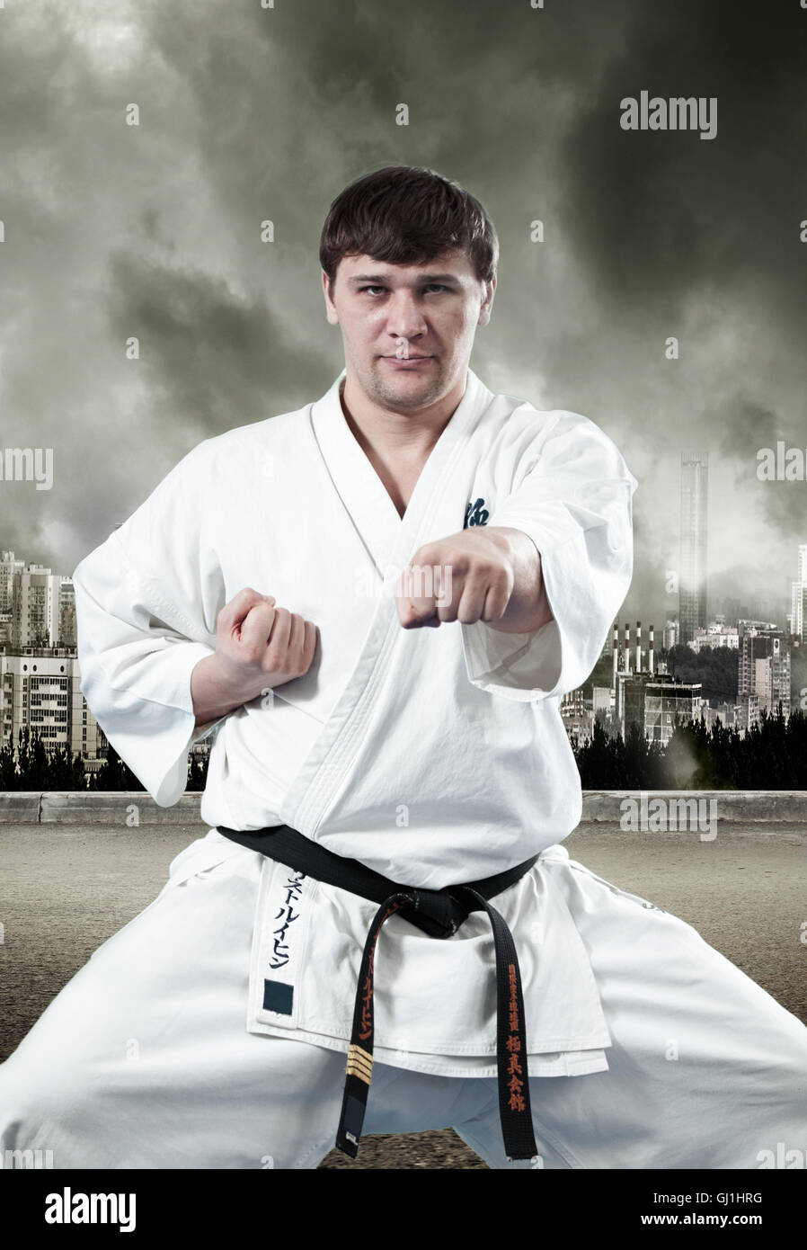 Karate master in kimono on stormy sky background Stock Photo - Alamy