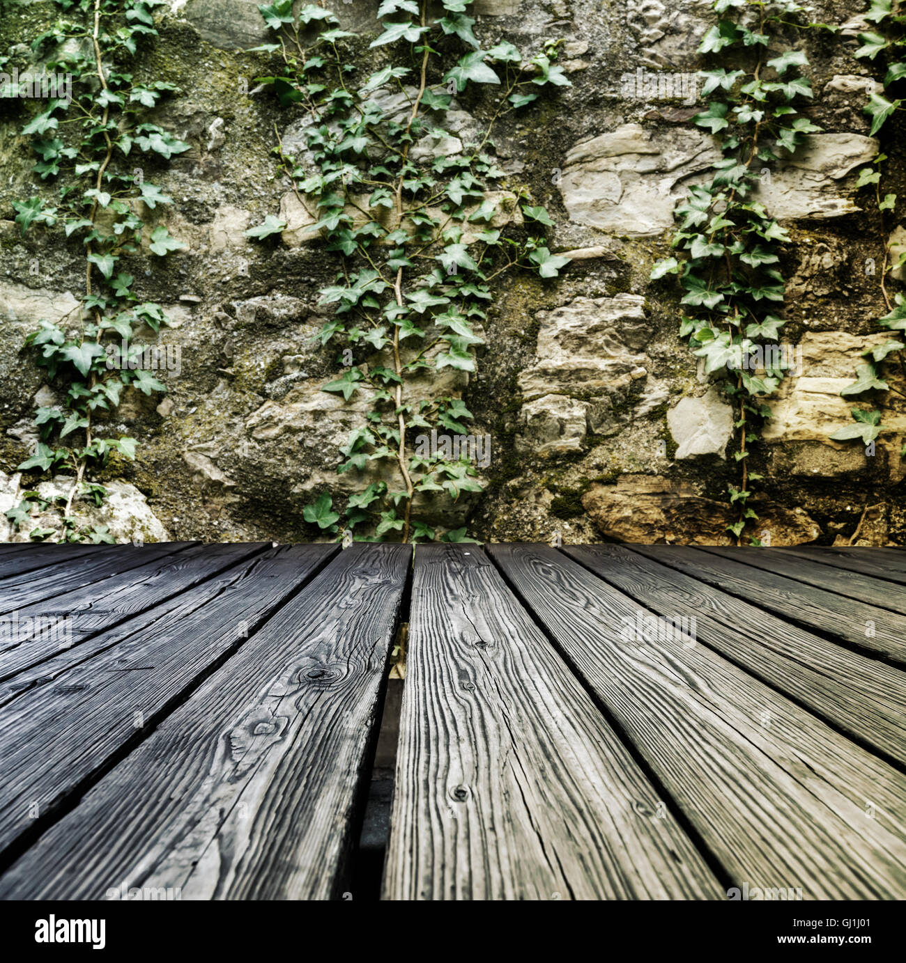 Rostrum made of wooden planks on stone wall background Stock Photo - Alamy