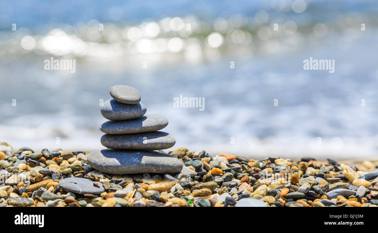 Seashore background with stone construction in closeup Stock Photo - Alamy