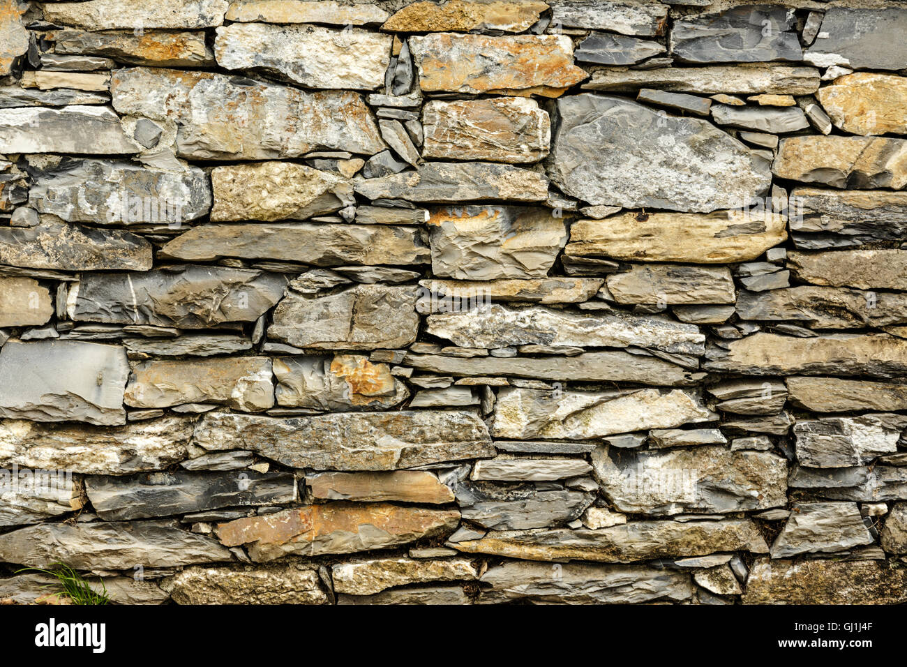 Ancient stone wall in closeup as background Stock Photo - Alamy