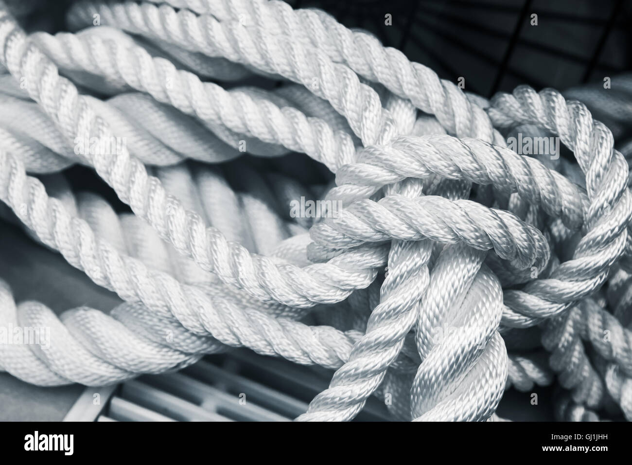 White nautical rope bundle, close up photo with blue tonal filter Stock ...